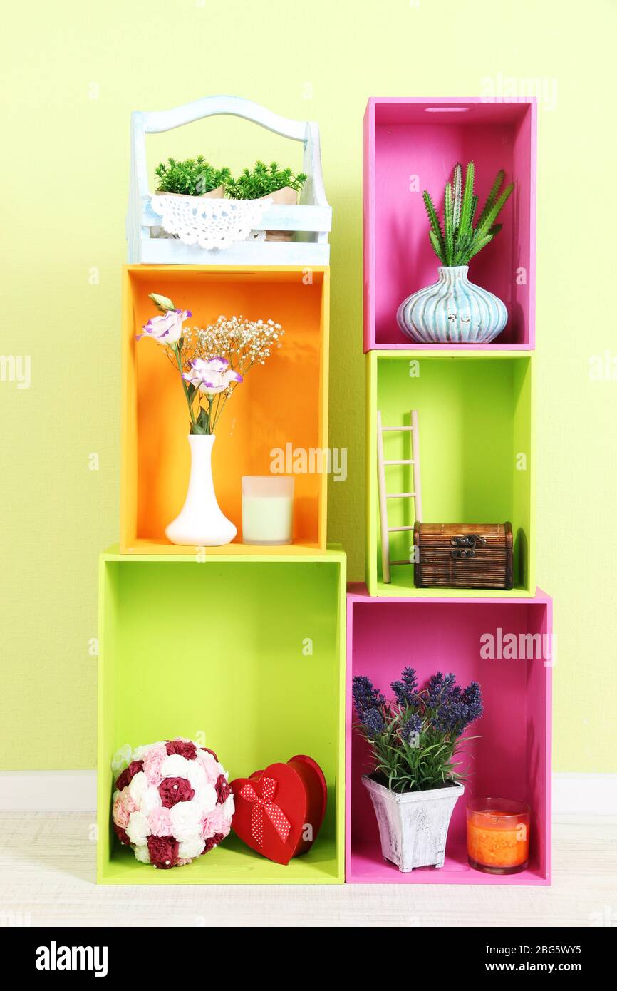 Shelves of different bright colors with decorative addition on wall ...