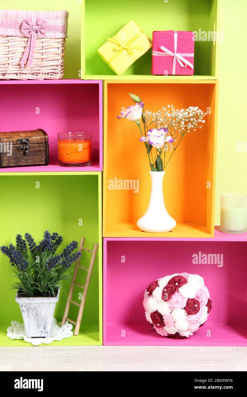 Shelves of different bright colors with decorative addition on wall ...