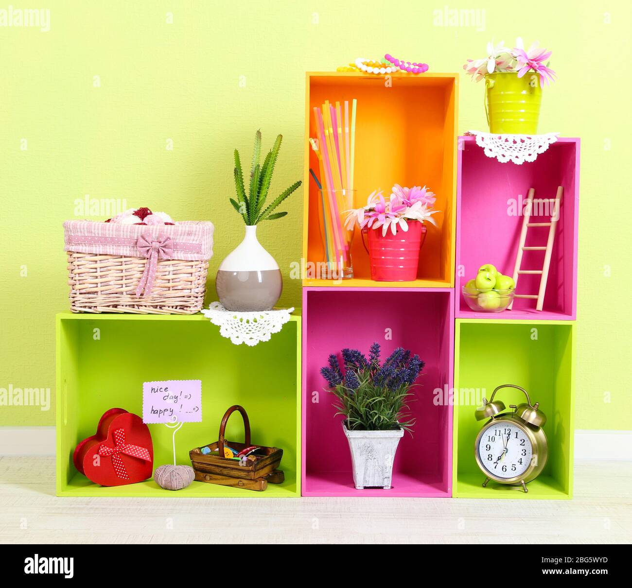 Shelves of different bright colors with decorative addition on wall ...