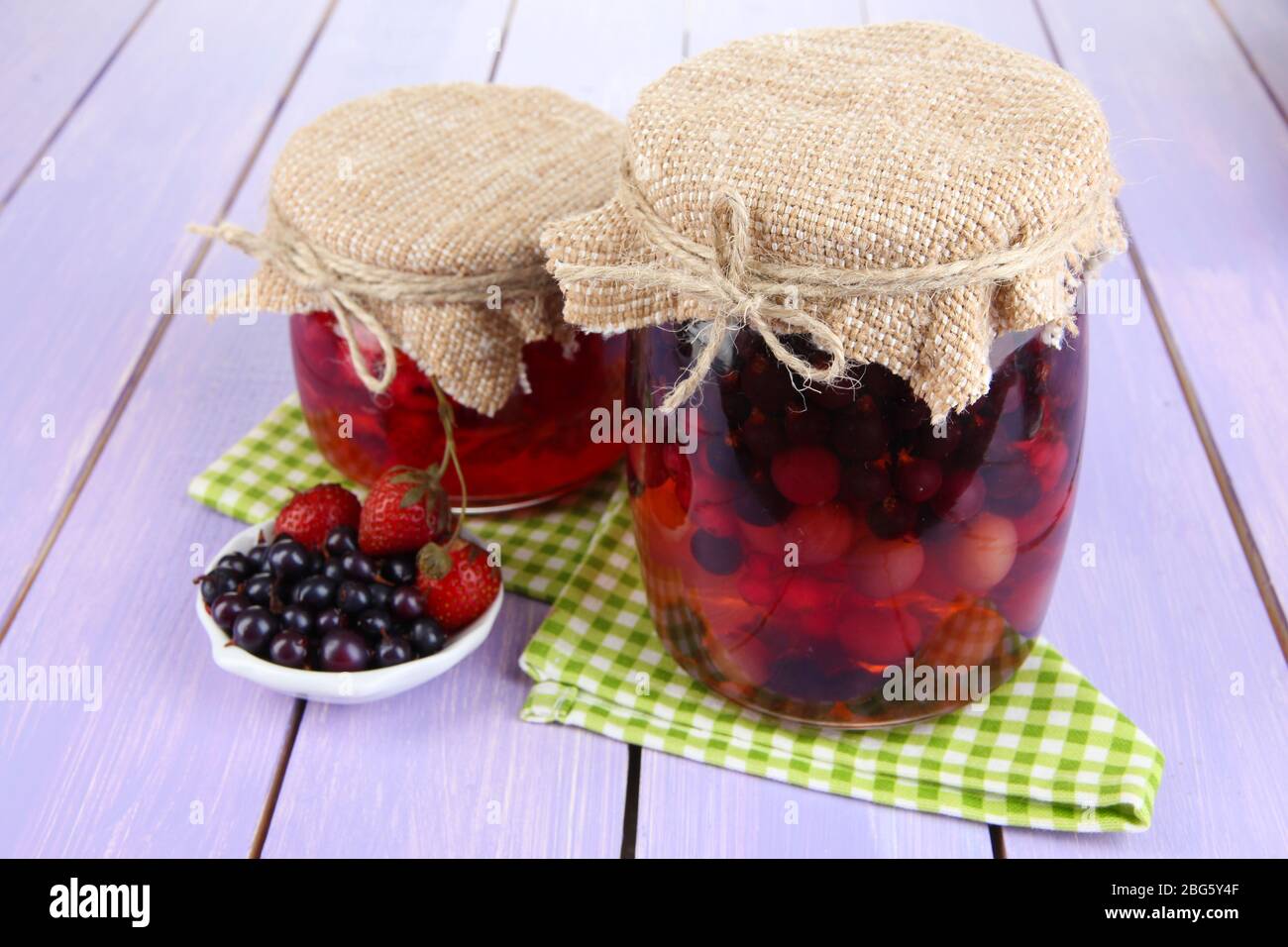 Home made berry jam on wooden table Stock Photo - Alamy