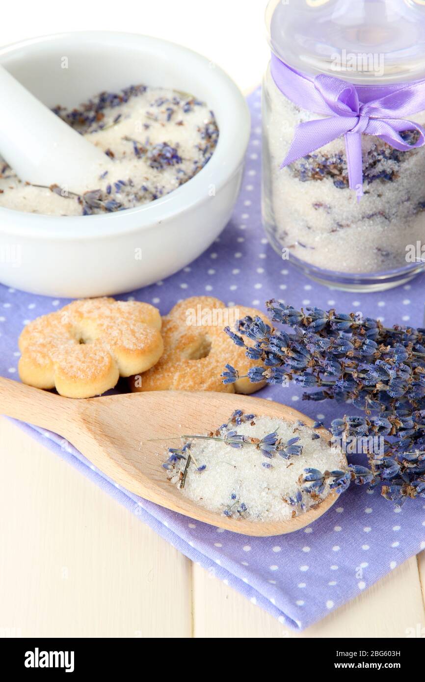 Still life with jar of lavender sugar, mortar and fresh lavender flowers on wooden background ...