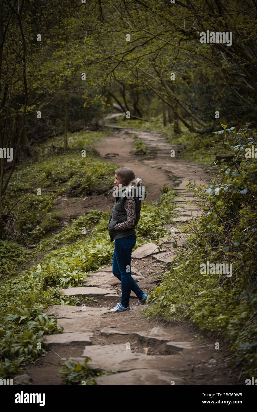 A young woman stood on a stone pavement path in the countryside Stock ...