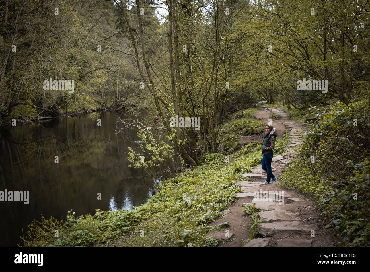 A young woman stood on a stone pavement path in the countryside Stock ...