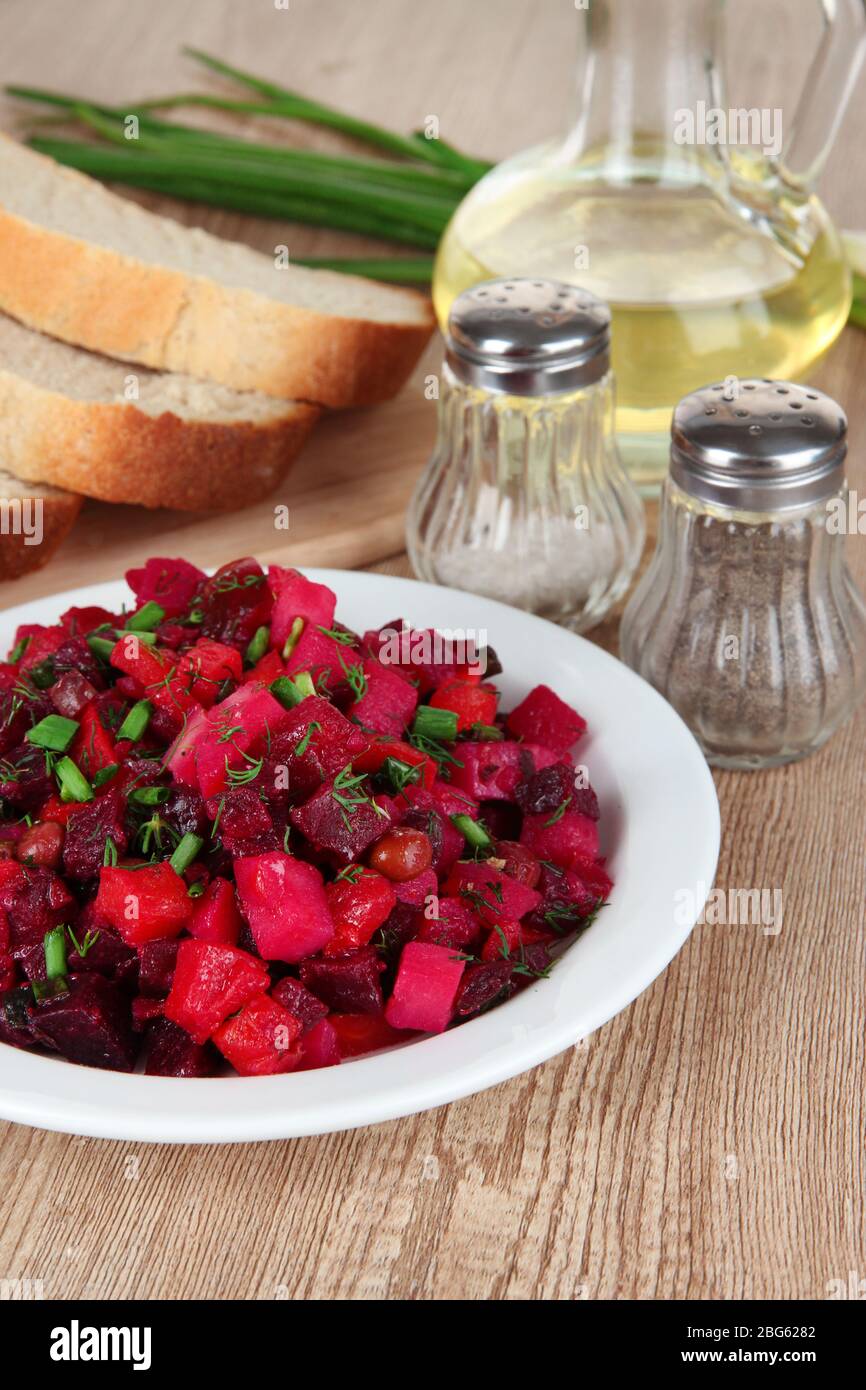 Beet salad in plate on table close-up Stock Photo - Alamy