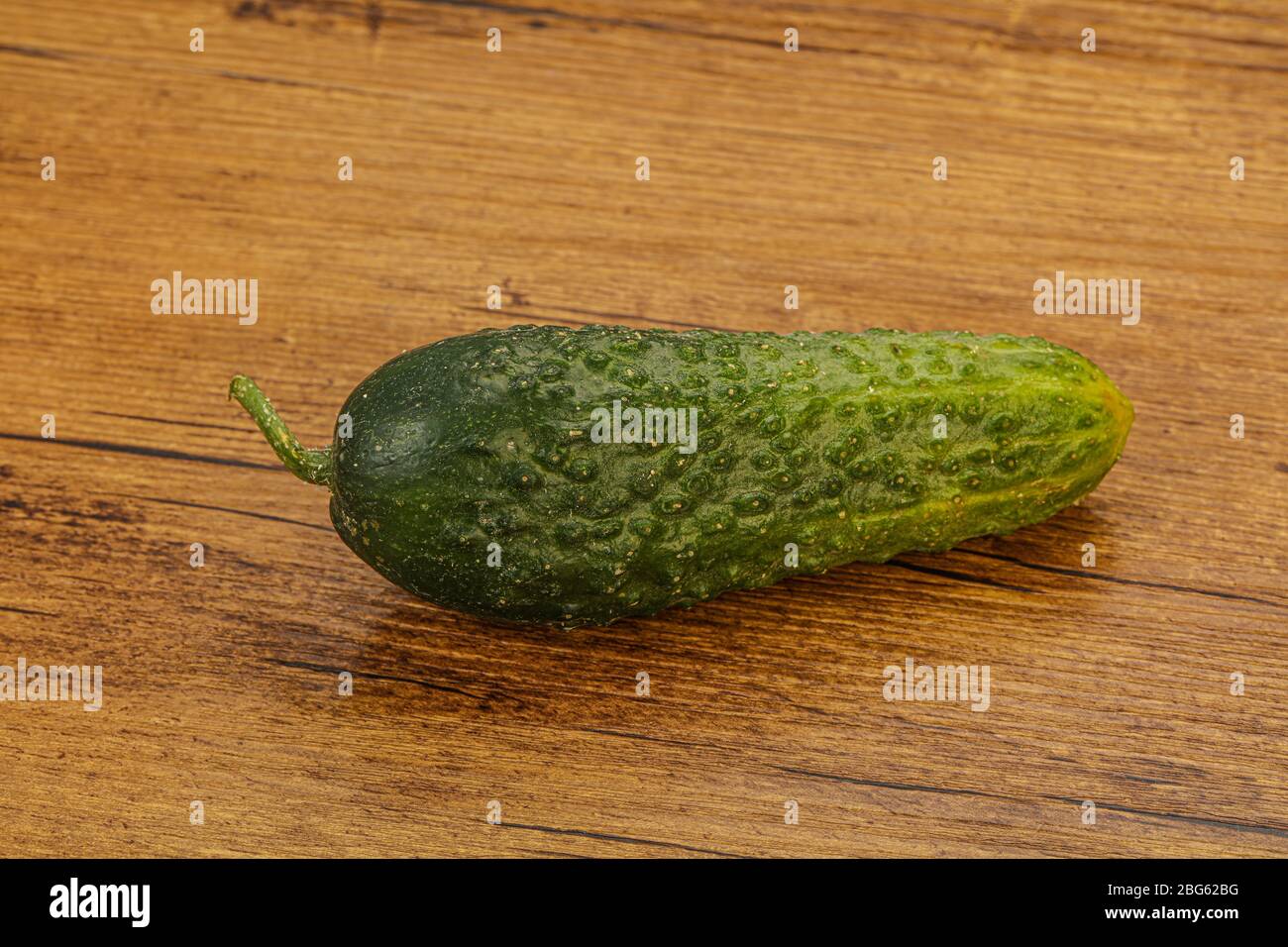 Green ripe fresh one cucumber over background Stock Photo - Alamy
