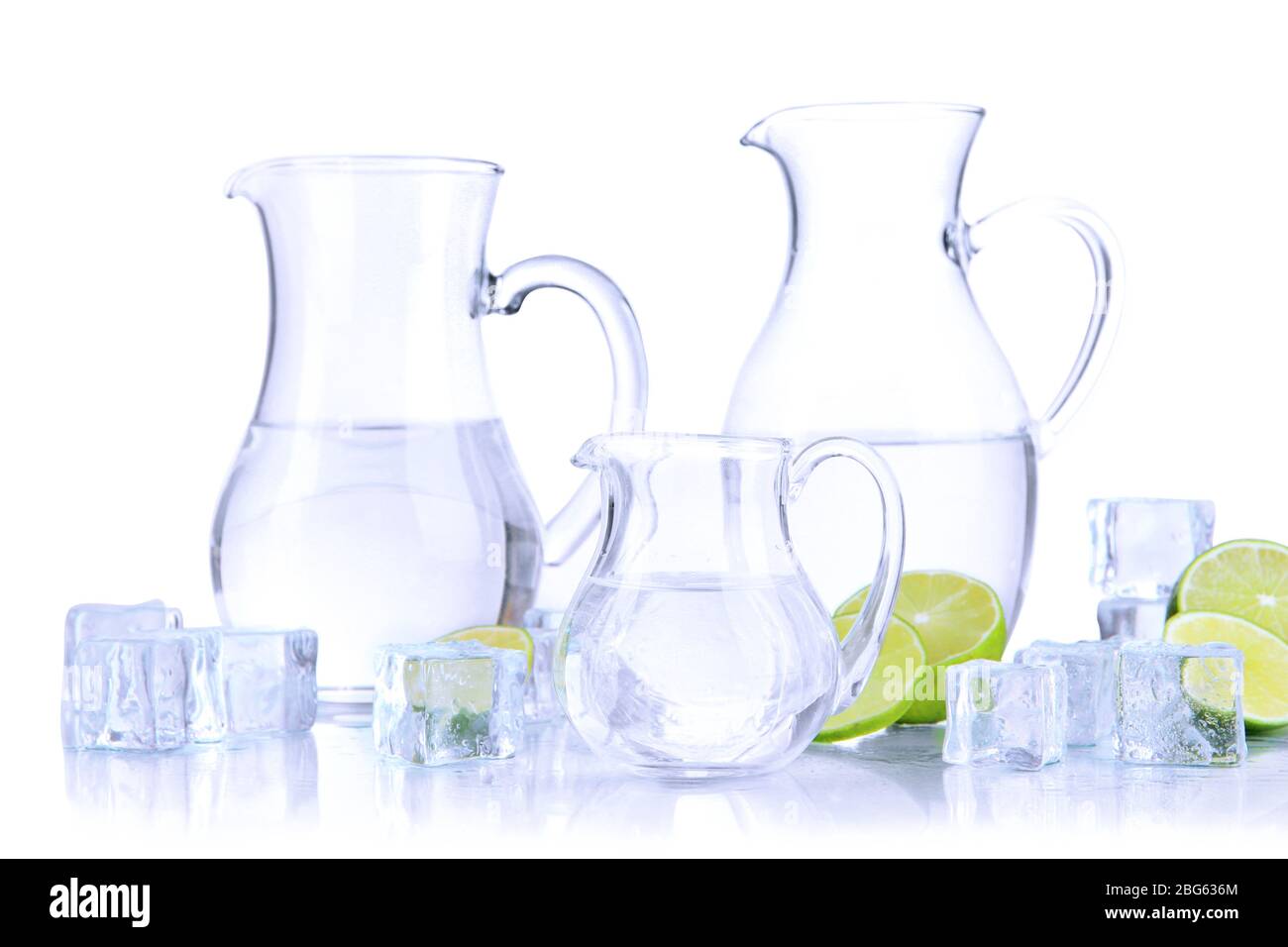 Glass pitchers of water with ice and lime isolated on white Stock Photo ...