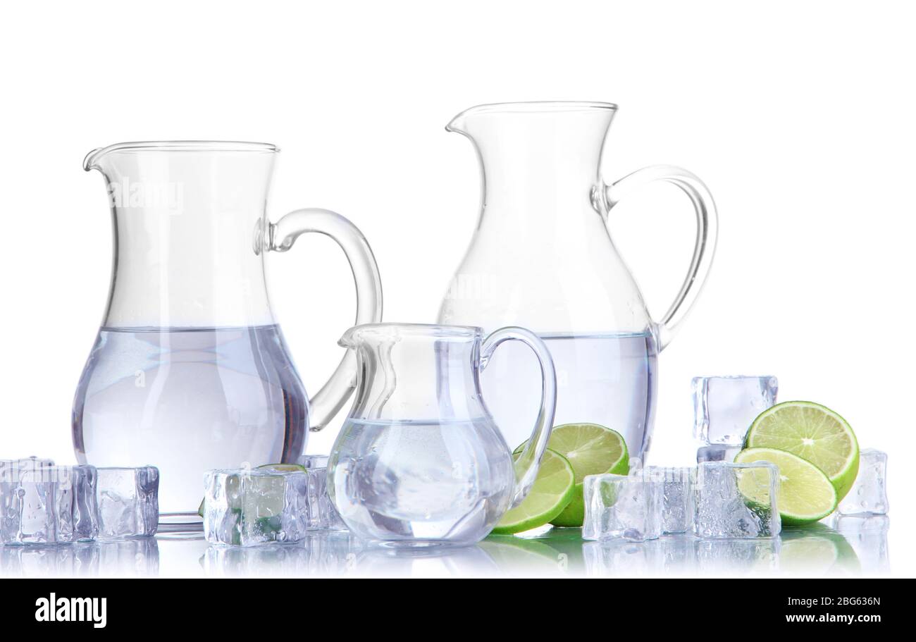 Glass pitchers of water with ice and lime isolated on white Stock Photo ...