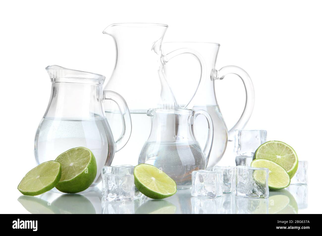 Glass pitchers of water with ice and lime isolated on white Stock Photo ...