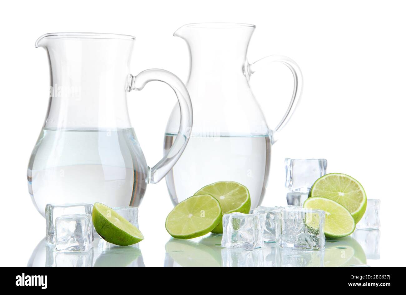 Glass pitchers of water with ice and lime isolated on white Stock Photo ...