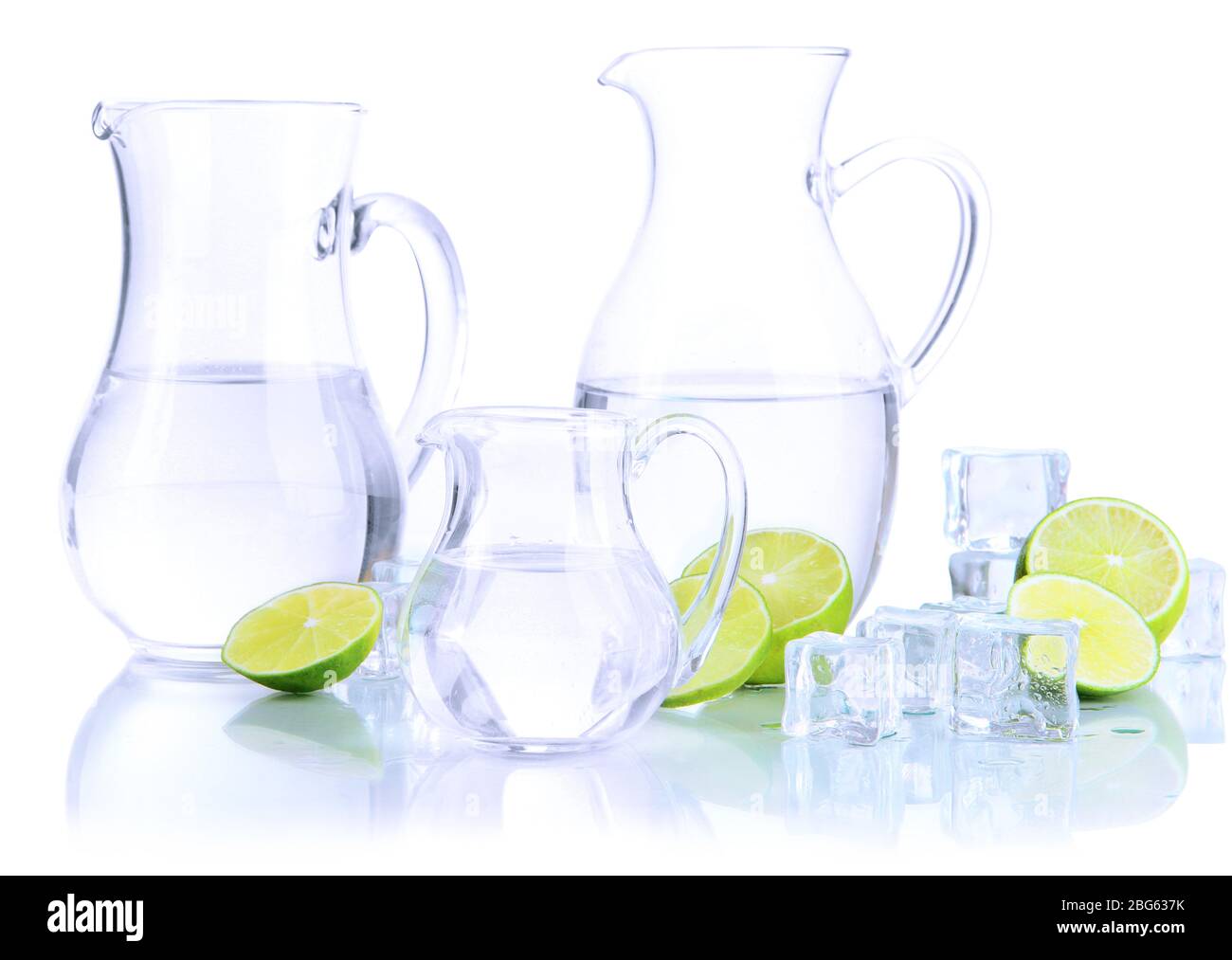 Glass pitchers of water with ice and lime isolated on white Stock Photo ...