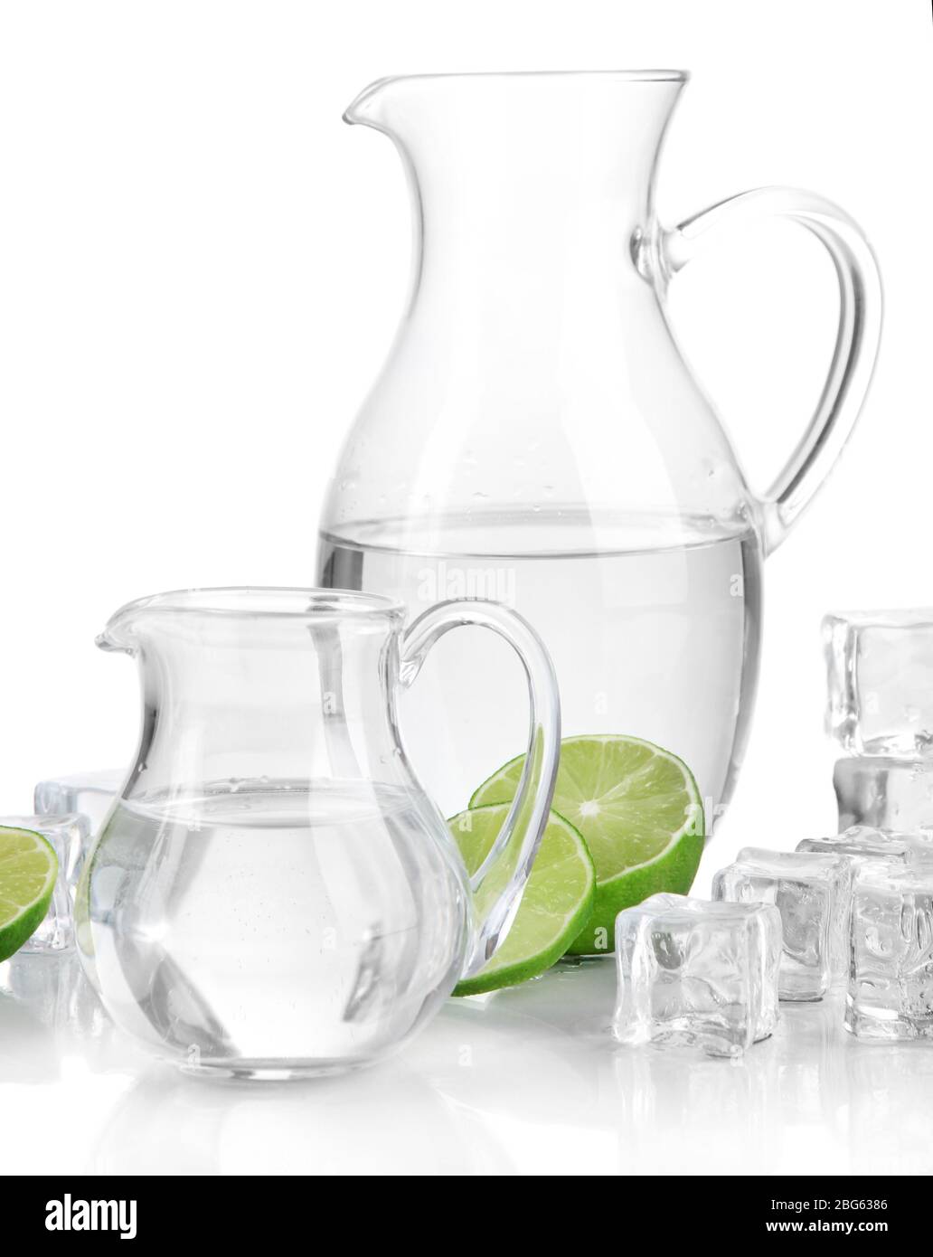Glass pitchers of water with ice and lime isolated on white Stock Photo ...
