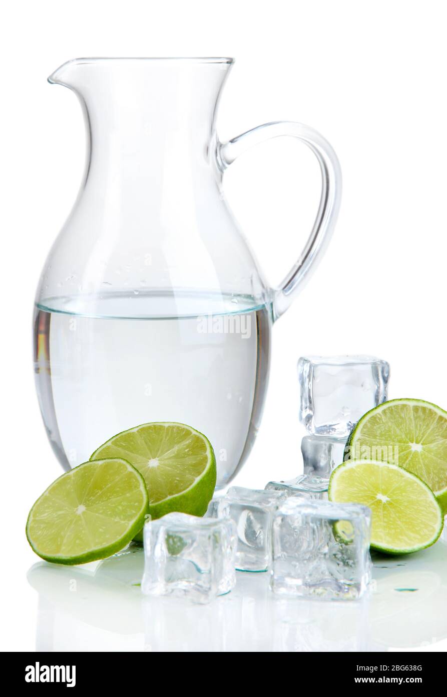 Glass pitcher of water with ice and lime isolated on white Stock Photo ...