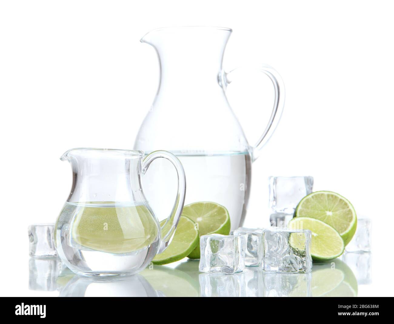 Glass pitchers of water with ice and lime isolated on white Stock Photo ...