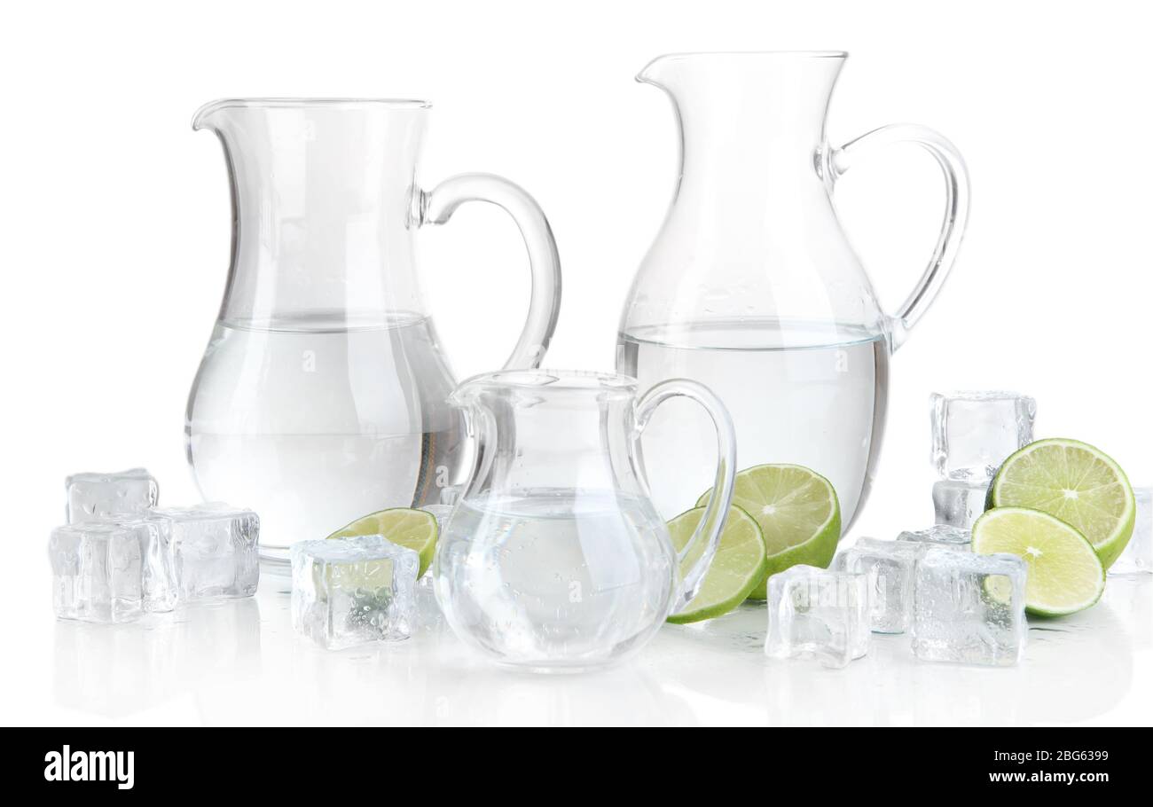 Glass pitchers of water with ice and lime isolated on white Stock Photo ...