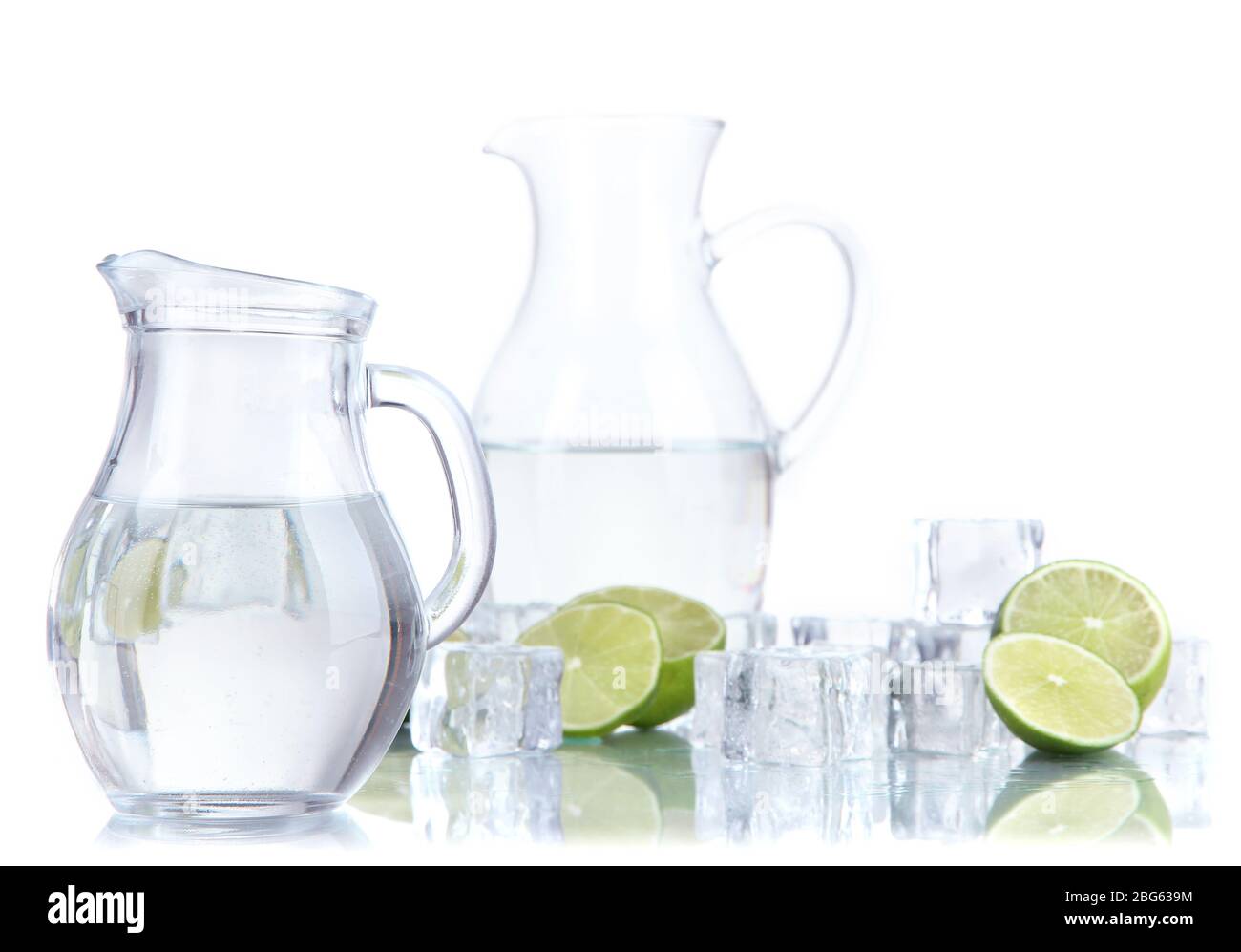 Glass pitchers of water with ice and lime isolated on white Stock Photo ...