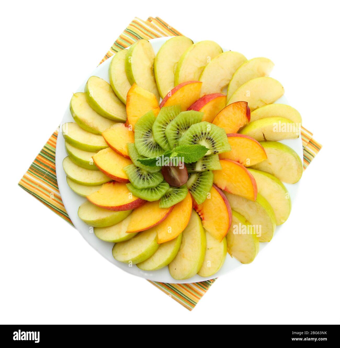 Assortment of sliced fruits on plate, isolated on white Stock Photo - Alamy