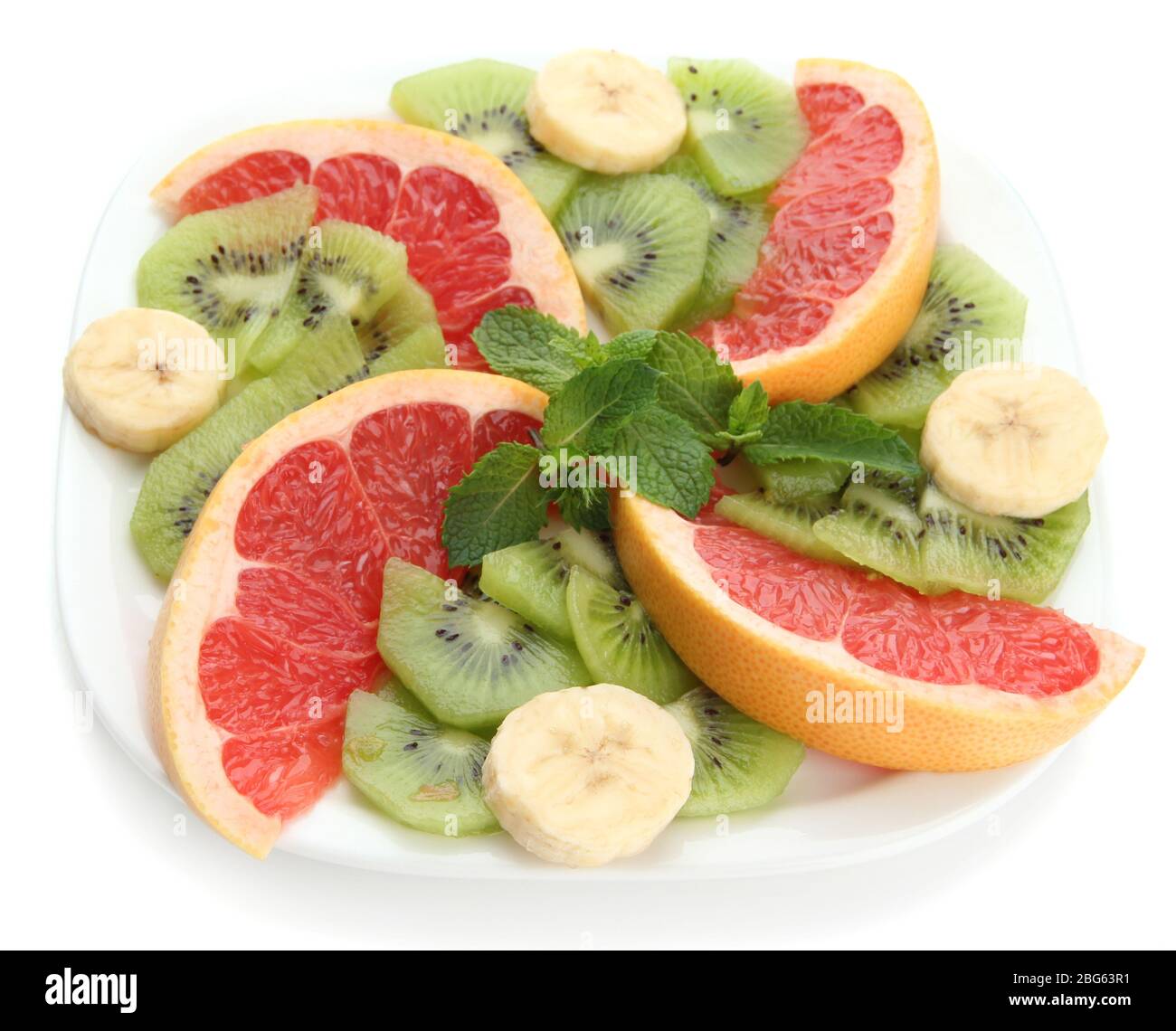 Assortment of sliced fruits on plate, isolated on white Stock Photo - Alamy