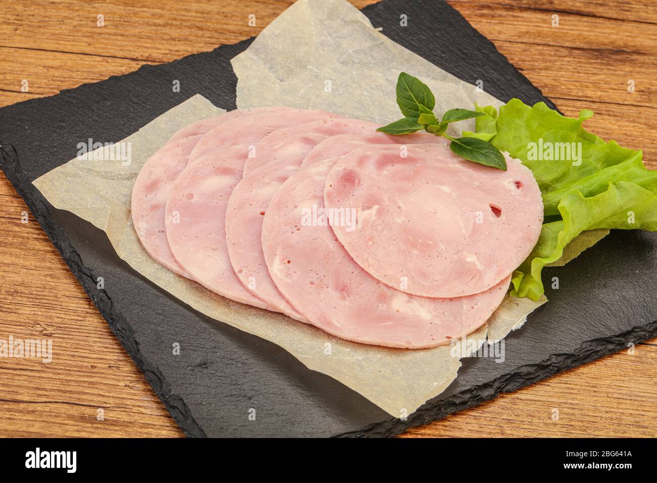 Slised ham pork snack over board Stock Photo - Alamy