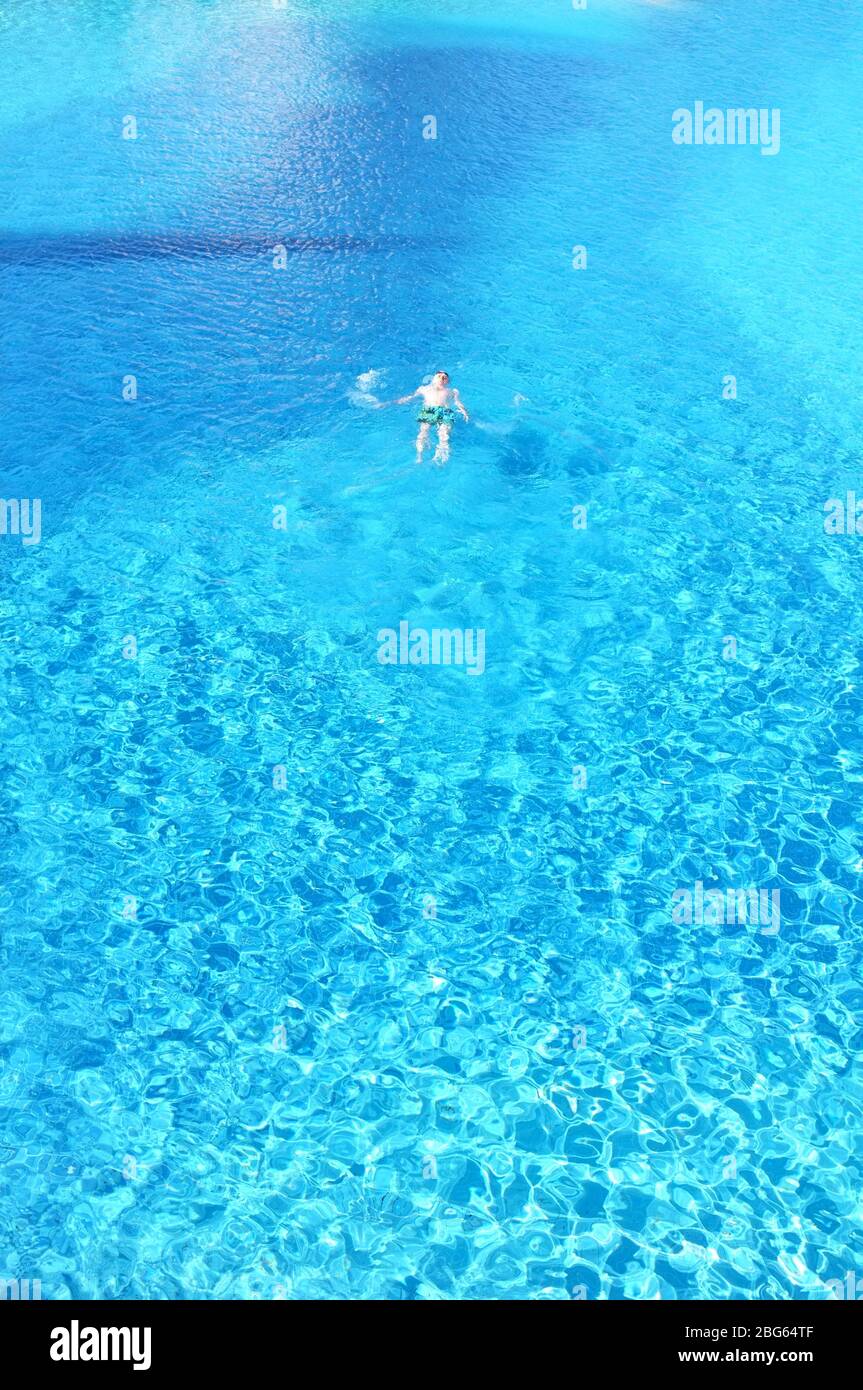 Relaxing in swimming pool Stock Photo - Alamy