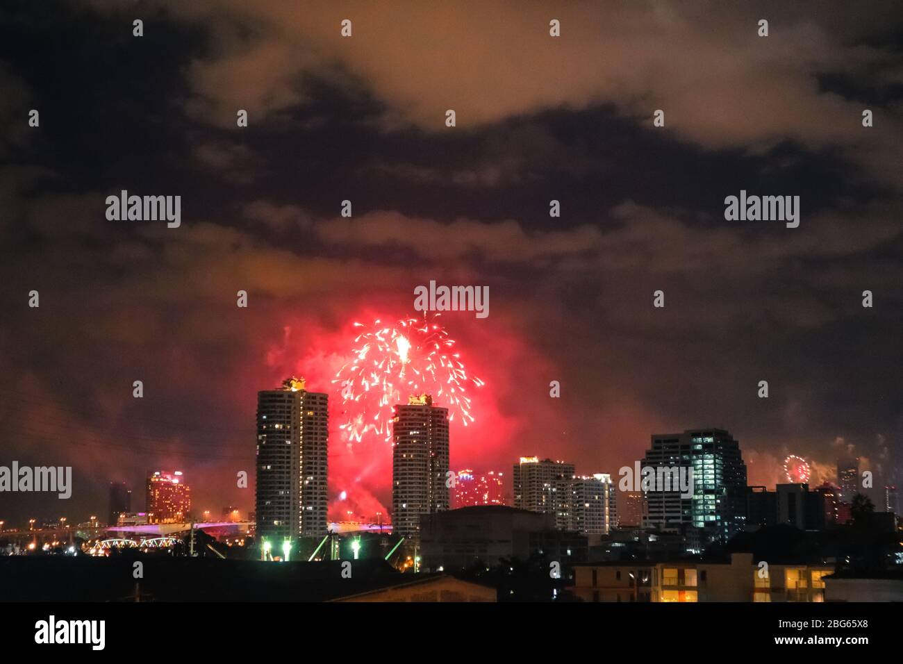 City at night in pyrotechnic explosions. fireworks on dark city sky ...