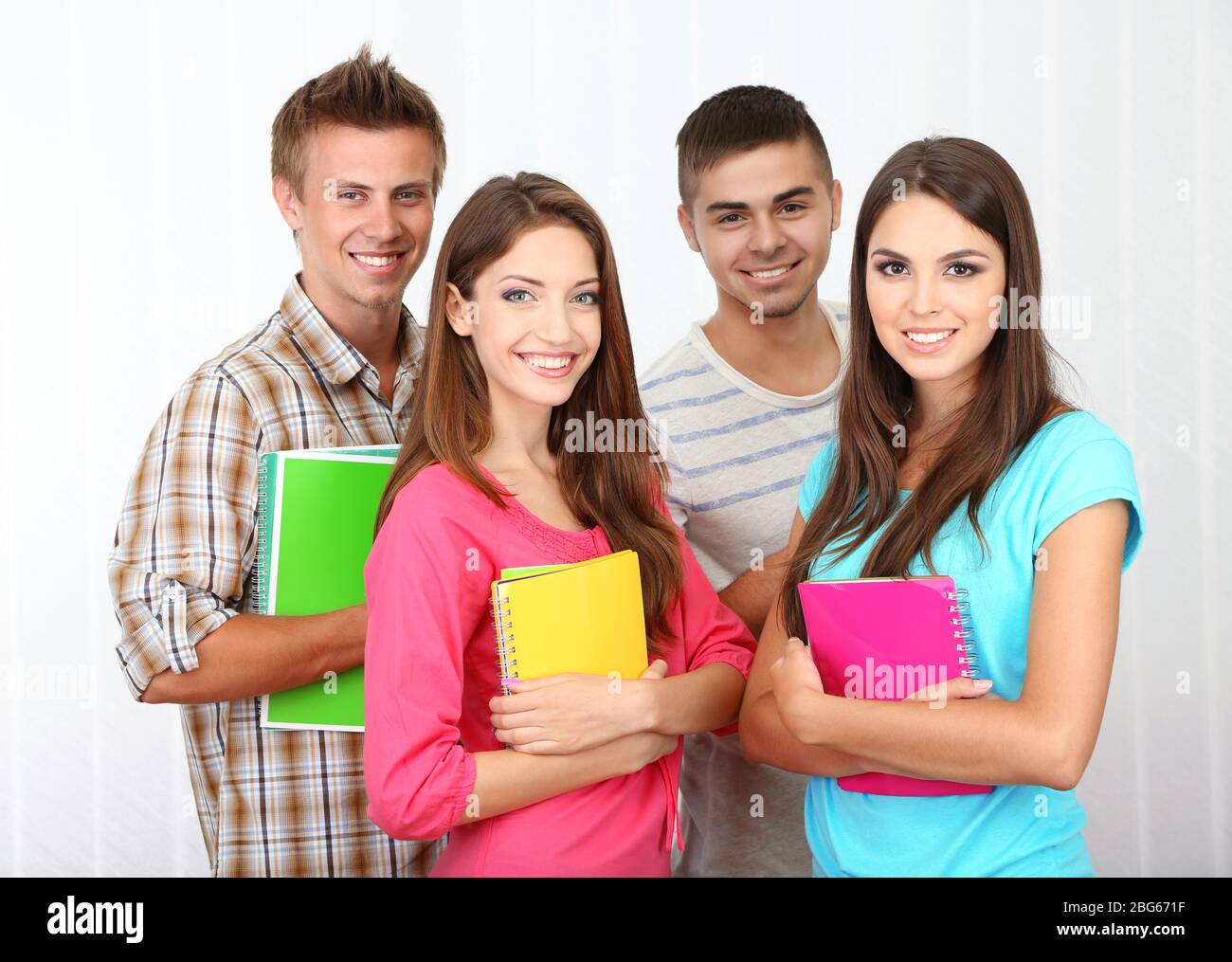 Group of happy beautiful young students at room Stock Photo - Alamy