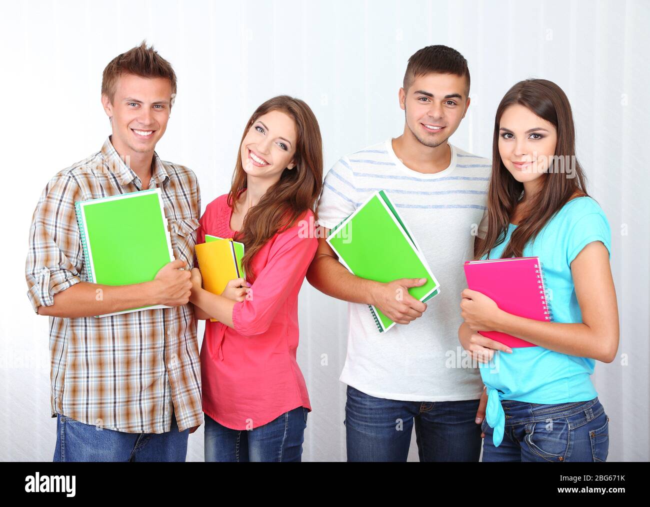 Group of happy beautiful young students at room Stock Photo - Alamy