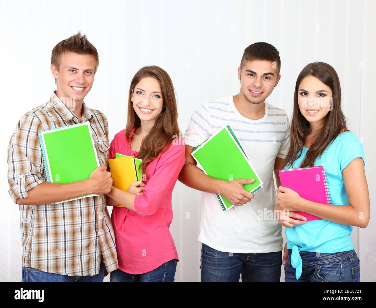 Group of happy beautiful young students at room Stock Photo - Alamy