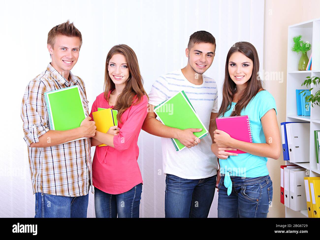 Group of happy beautiful young students at room Stock Photo - Alamy