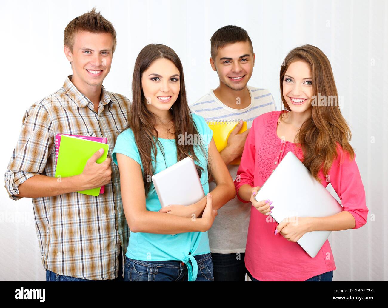 Group of happy beautiful young students at room Stock Photo - Alamy