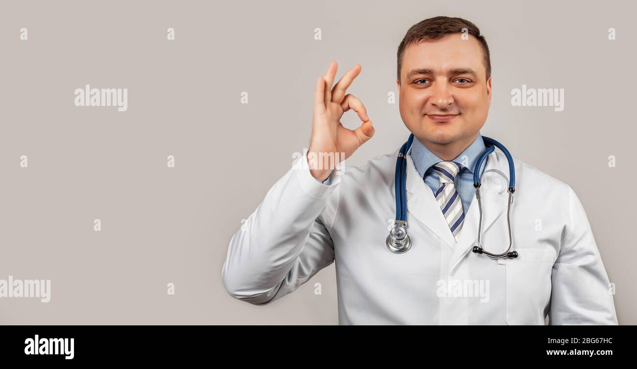Good job. Satisfied doctor man in a medical coat and with a stethoscope ...