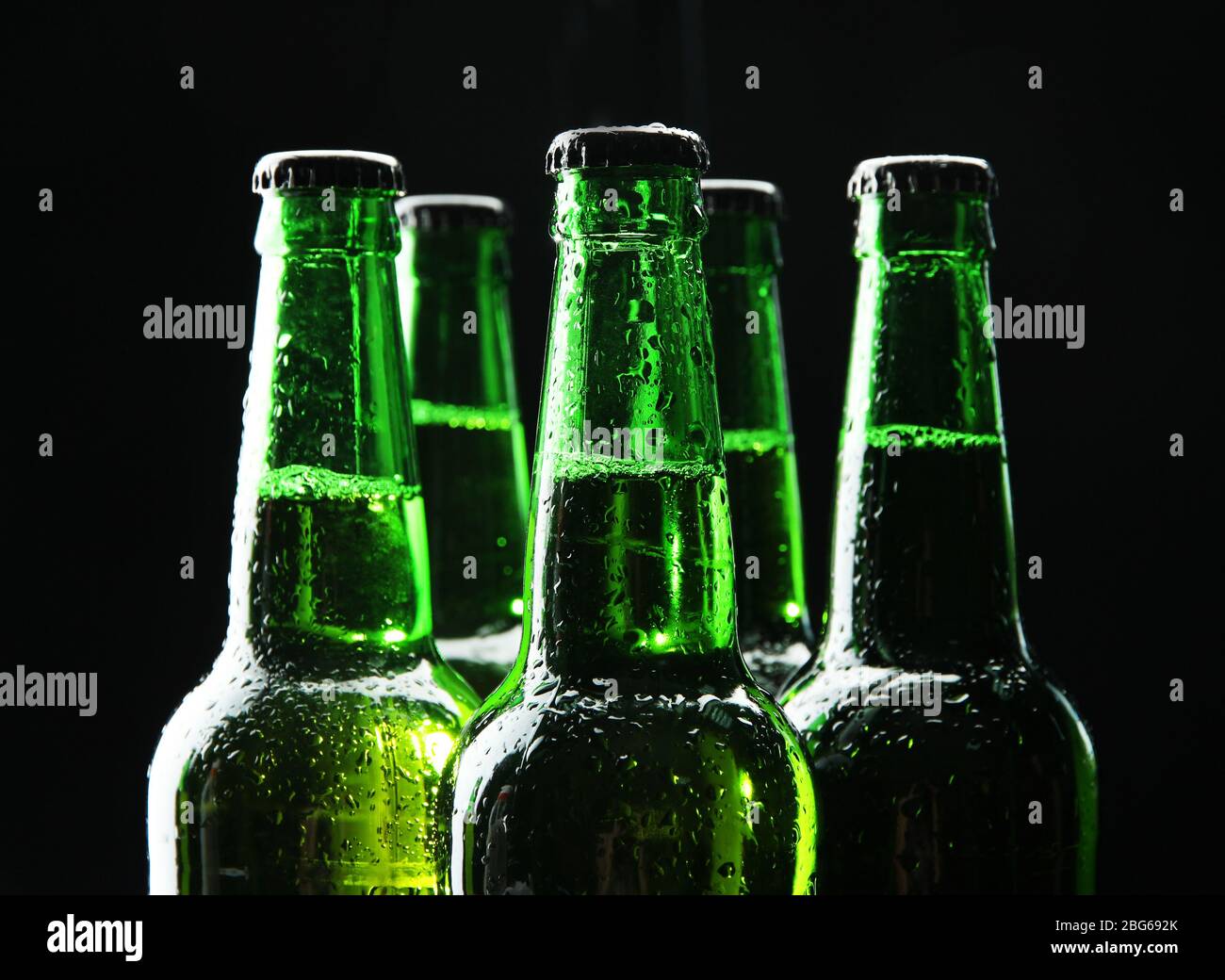 Bottles of beer on black background Stock Photo - Alamy