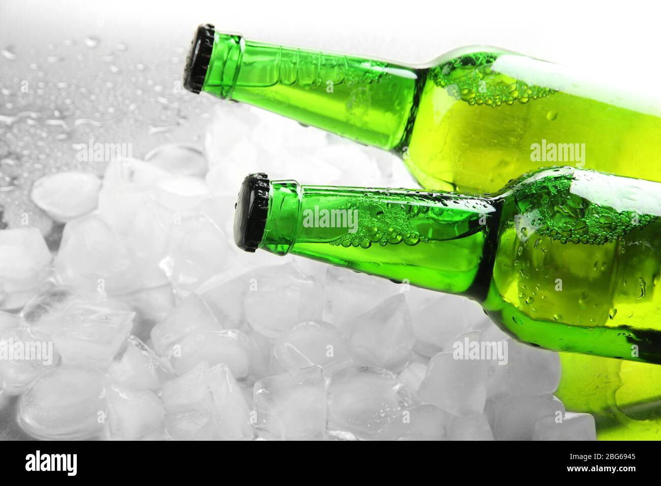 Bottles of beer with ice cubes, close up Stock Photo - Alamy