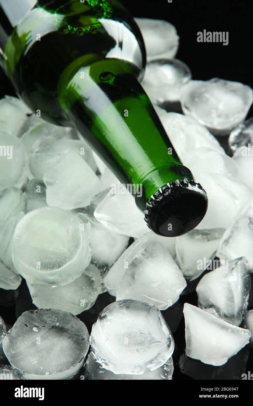 Bottle of beer with ice cubes, close up Stock Photo - Alamy