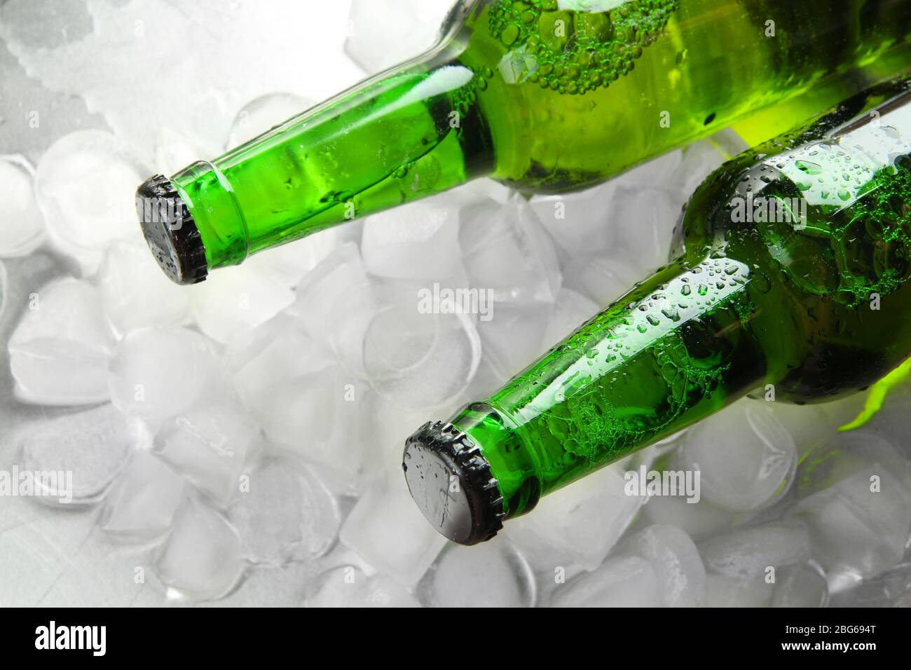 Bottles of beer with ice cubes, close up Stock Photo - Alamy