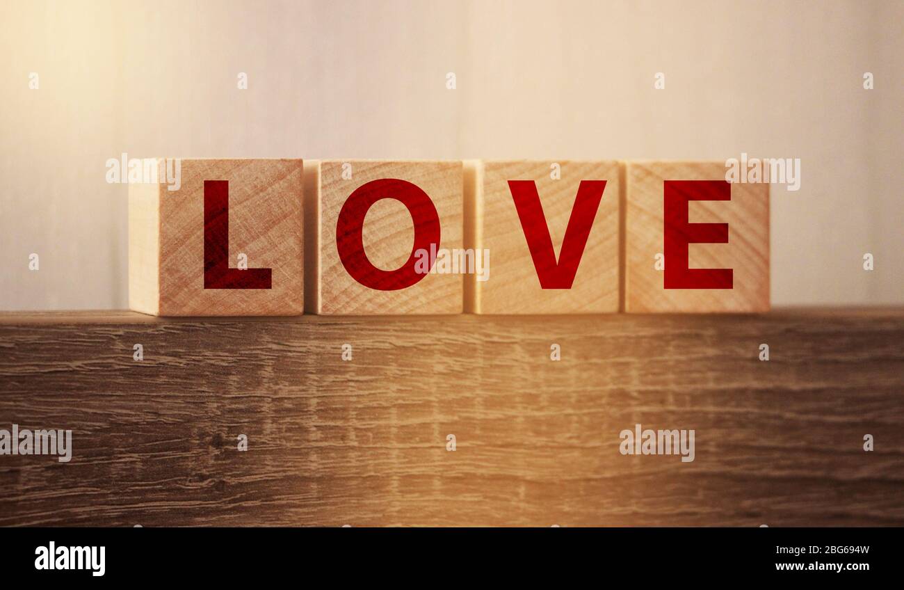 LOVE word from letter wooden blocks on wooden background. Relationship ...