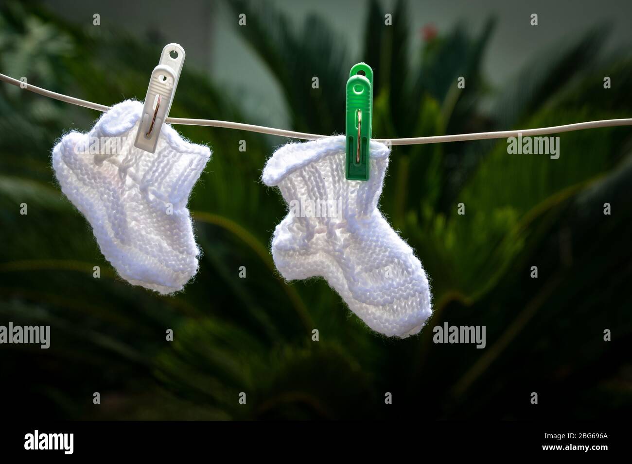 Baby clothes on washing line hi-res stock photography and images - Alamy