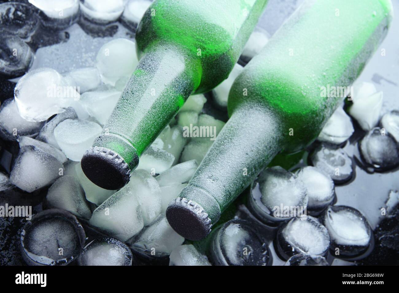 Bottles of beer with ice cubes, close up Stock Photo - Alamy