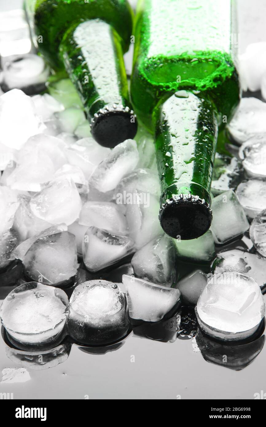 Bottles of beer with ice cubes, close up Stock Photo - Alamy