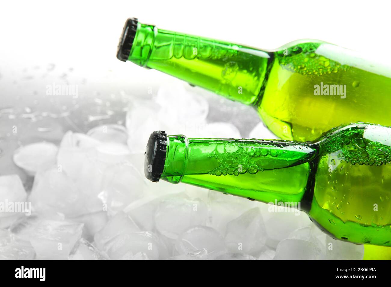 Bottles of beer with ice cubes, close up Stock Photo - Alamy