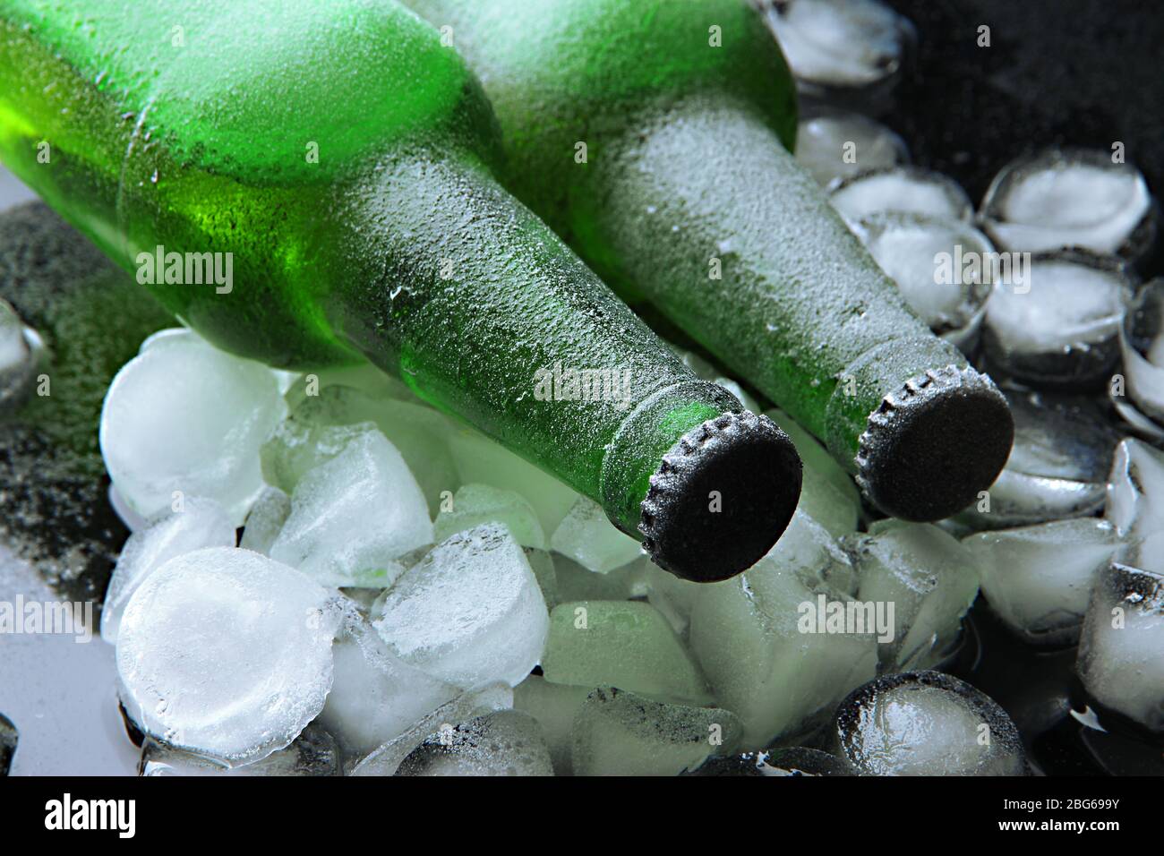 Bottles of beer with ice cubes, close up Stock Photo - Alamy