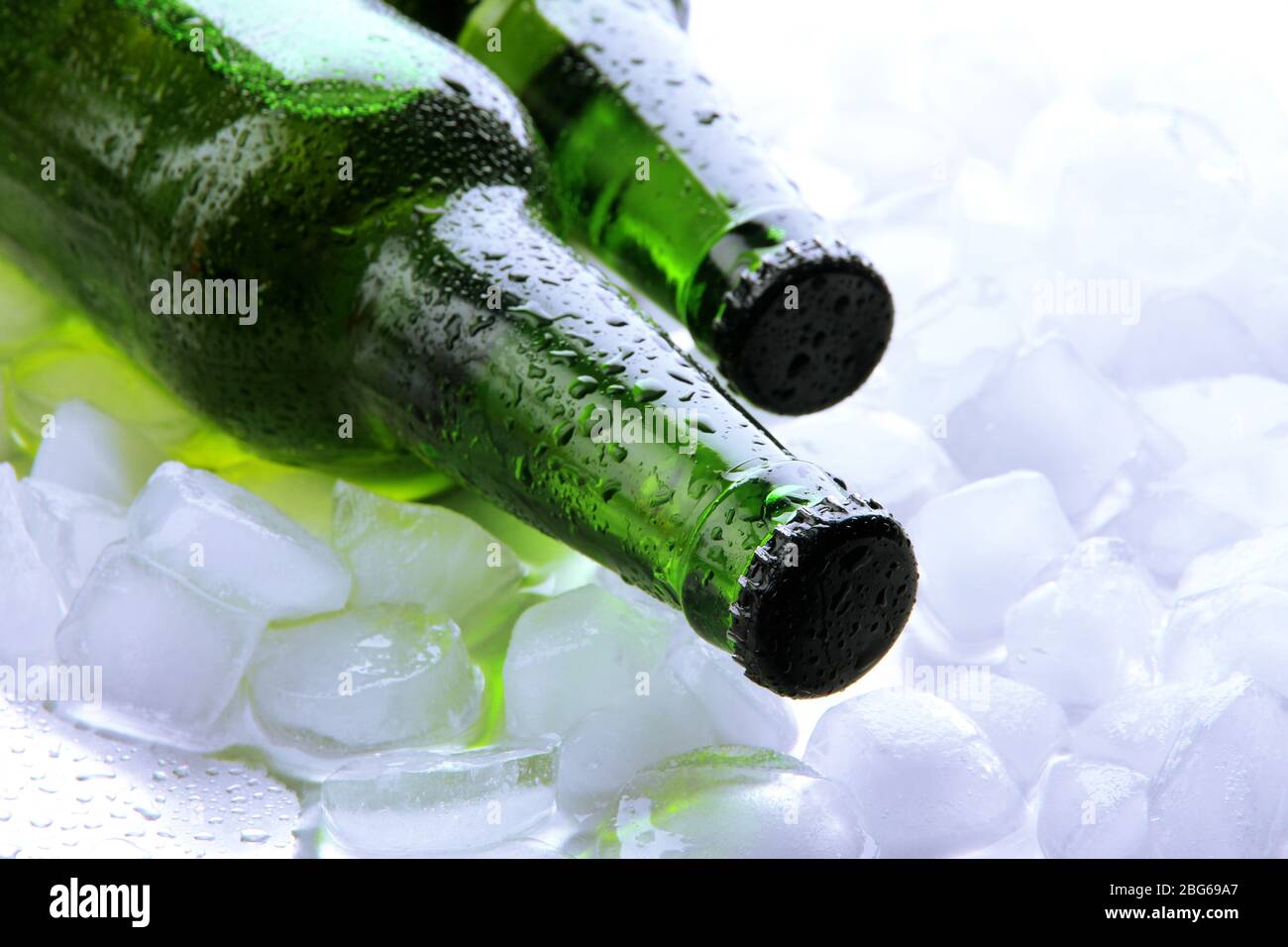Bottles of beer with ice cubes, close up Stock Photo - Alamy