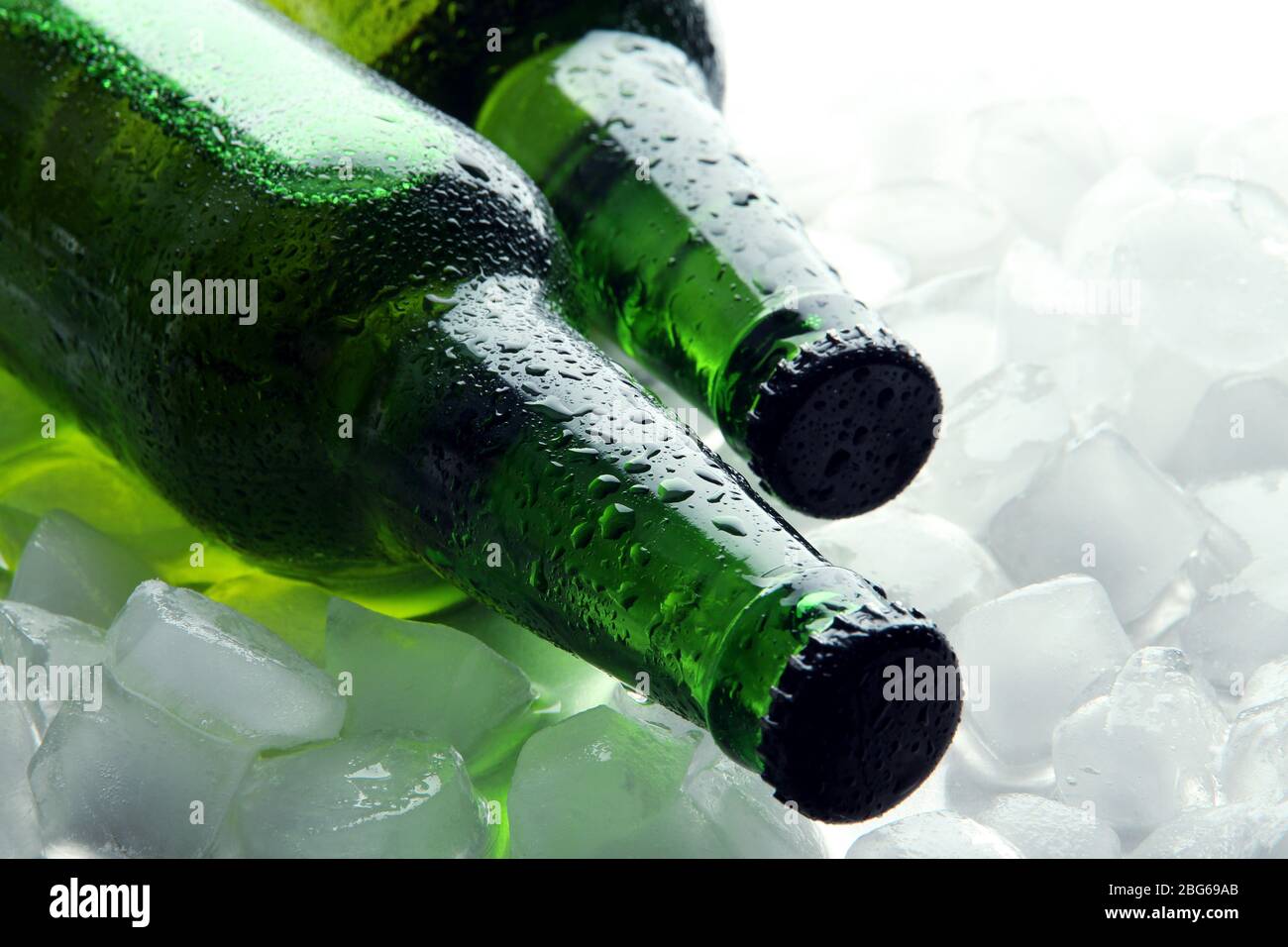 Bottles of beer with ice cubes, close up Stock Photo - Alamy