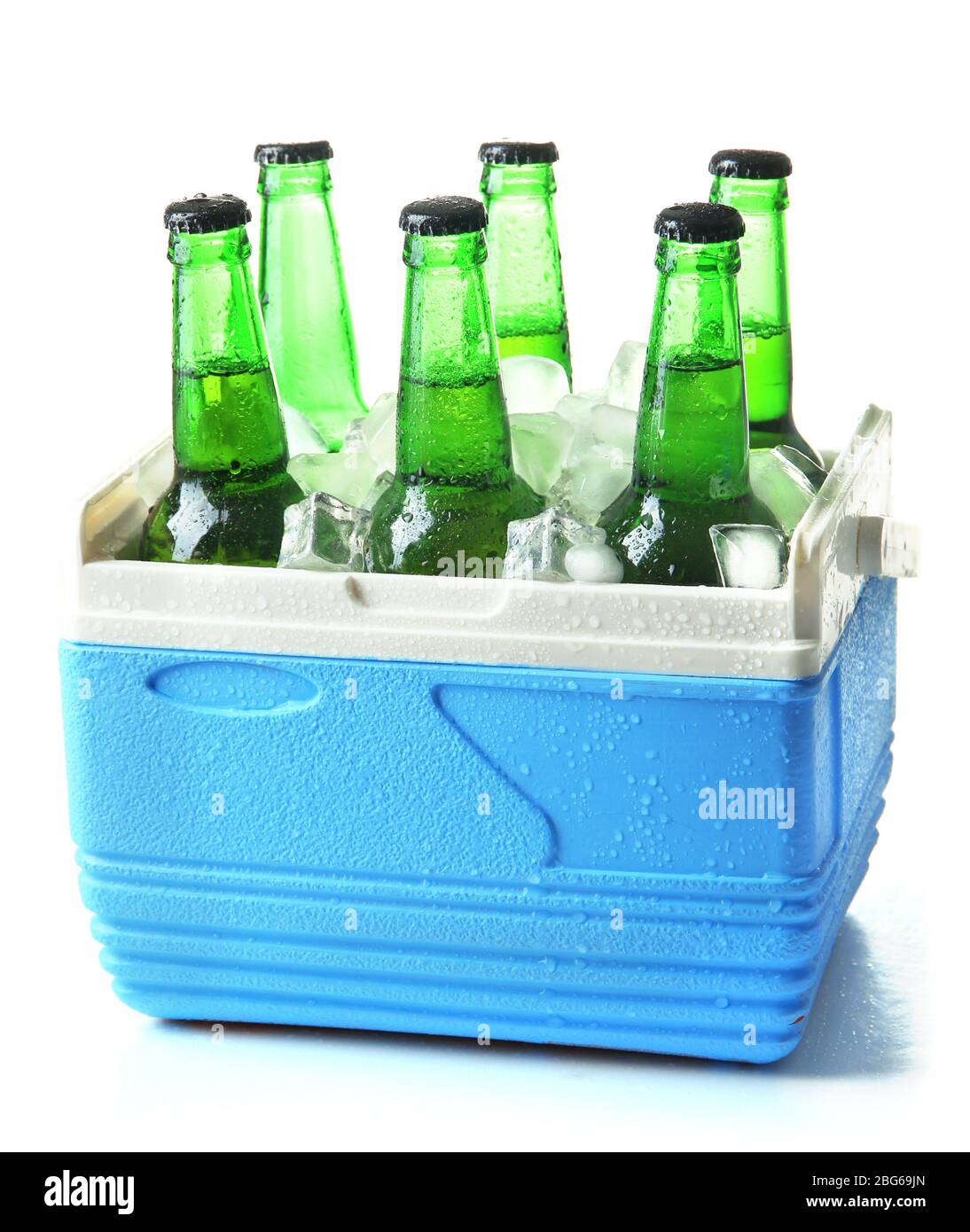 Bottles of beer with ice cubes in mini refrigerator, isolated on white ...