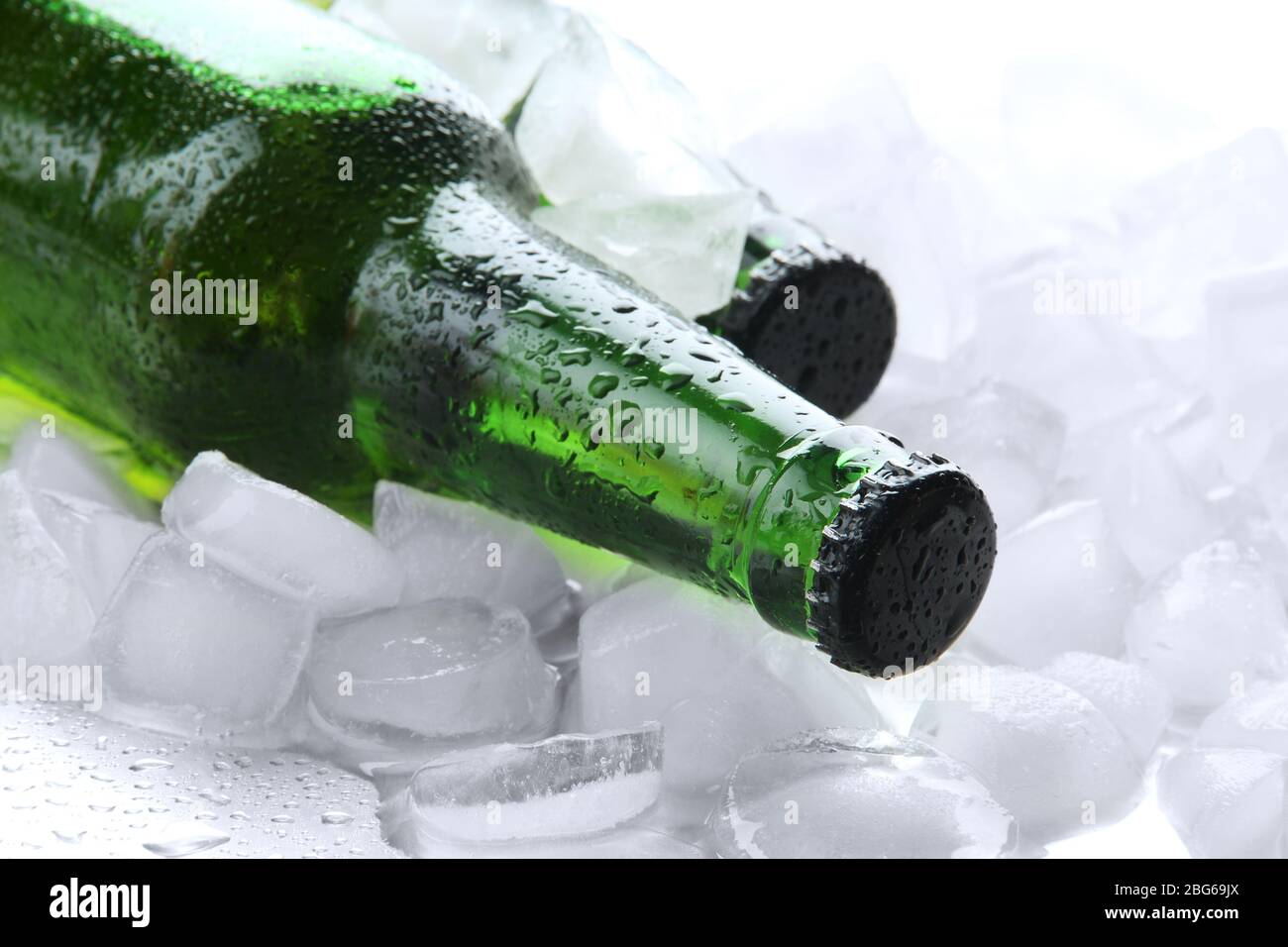 Bottles of beer with ice cubes, close up Stock Photo - Alamy