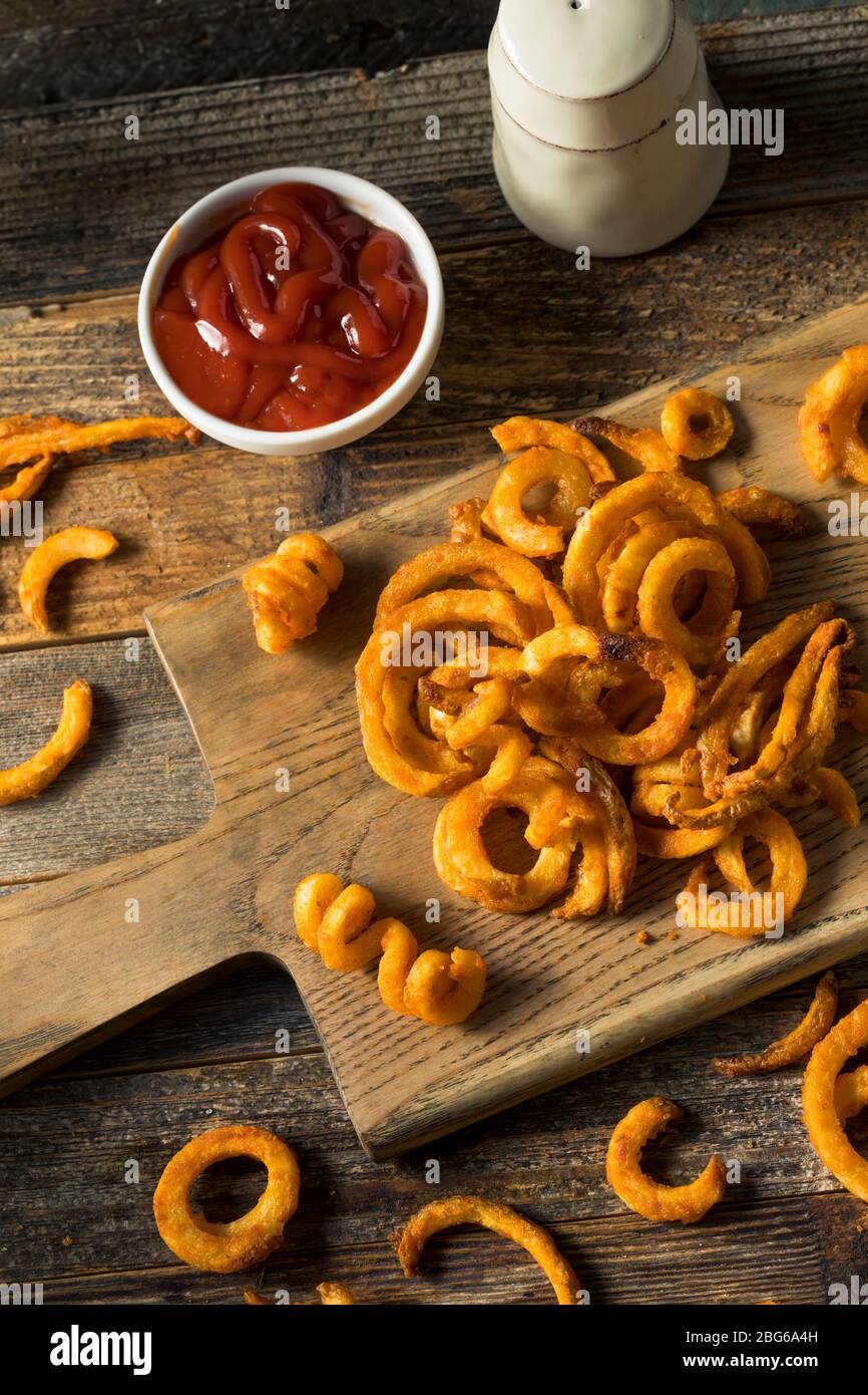 Homemade Seasoned Curly French Fries with Ketchup Stock Photo - Alamy