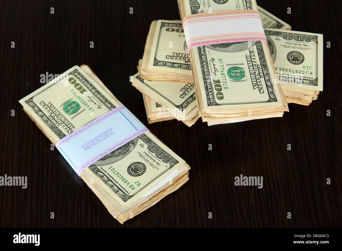 Stacks of money on wooden table Stock Photo - Alamy