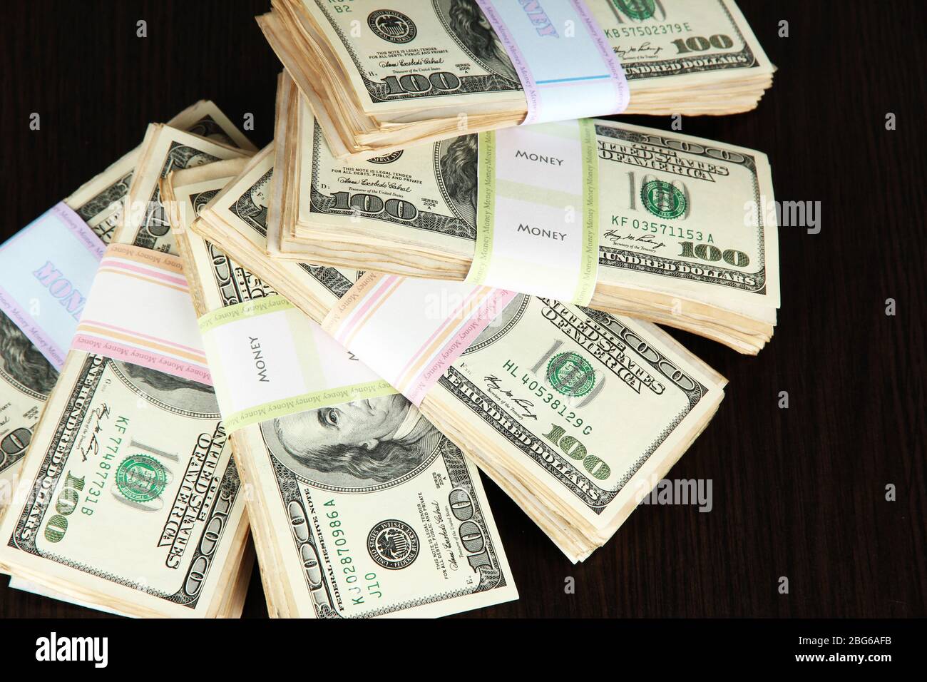 Stacks of money on wooden table Stock Photo - Alamy