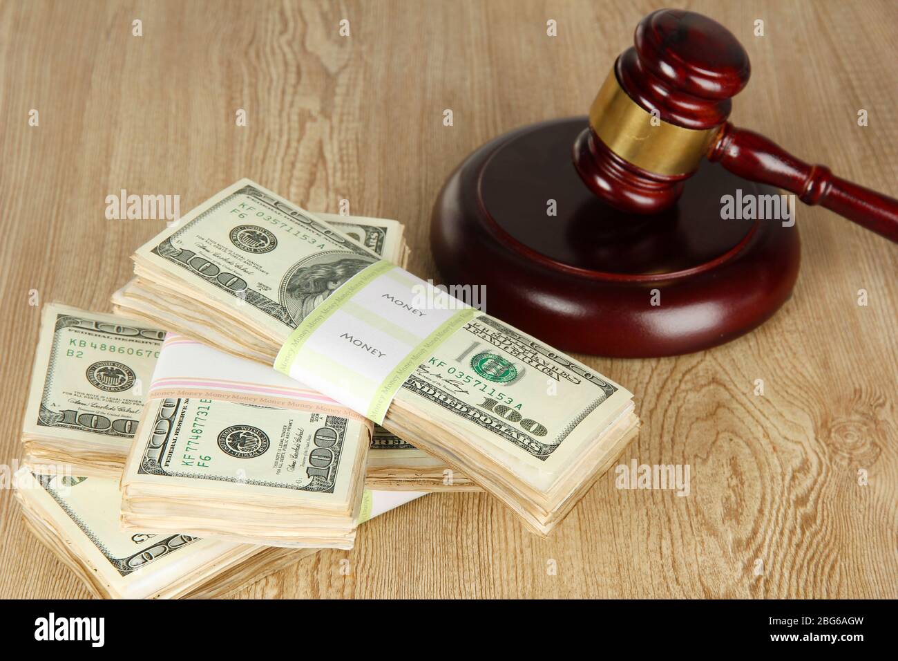 Stacks of money and judges gavel on wooden table Stock Photo - Alamy