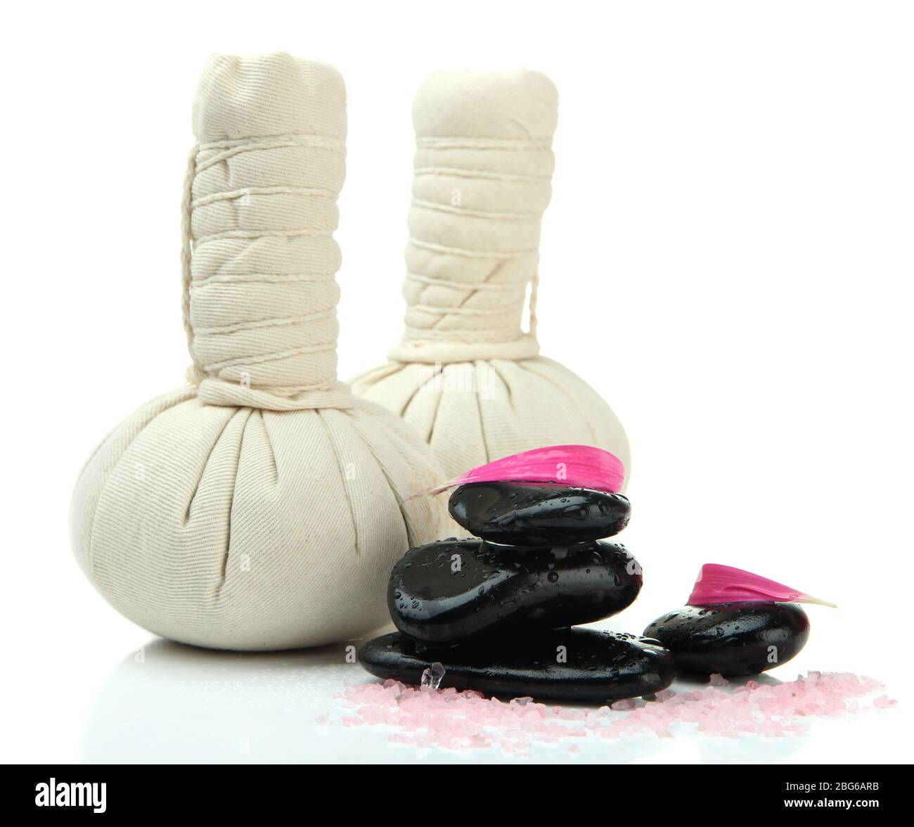 Herbal compress balls for spa treatment and spa stones isolated on ...