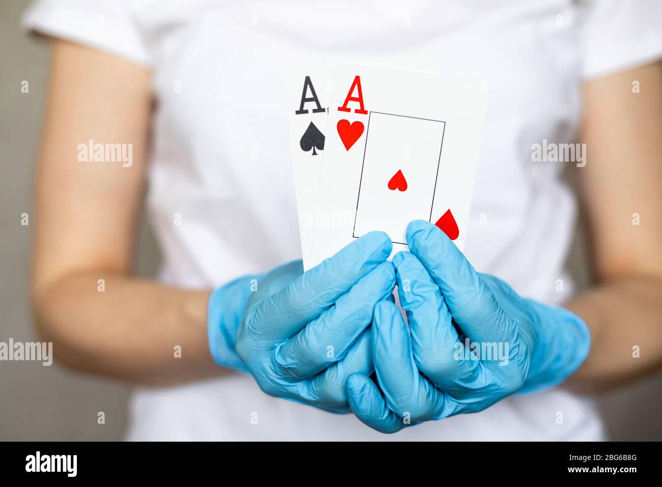 Young woman with disposable protective gloves holding cards - pair of ...